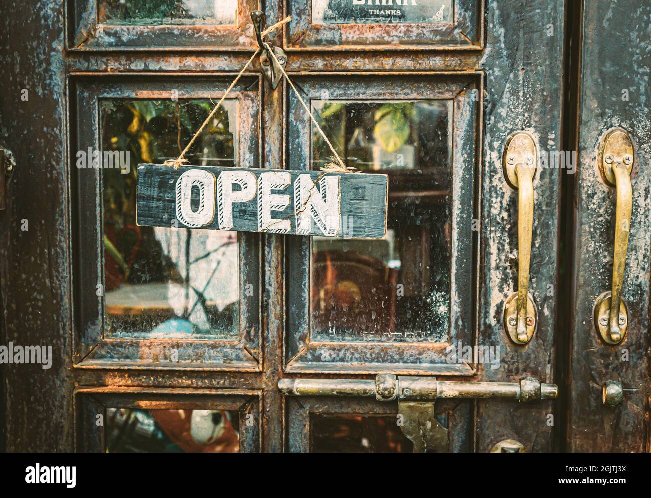 Open Sign Hanging on vintage door Stock Photo - Alamy