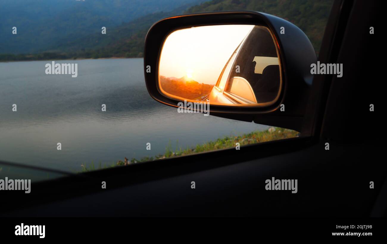 orange landscape sunset reflect in mirror of car.Rear View Mirror ...