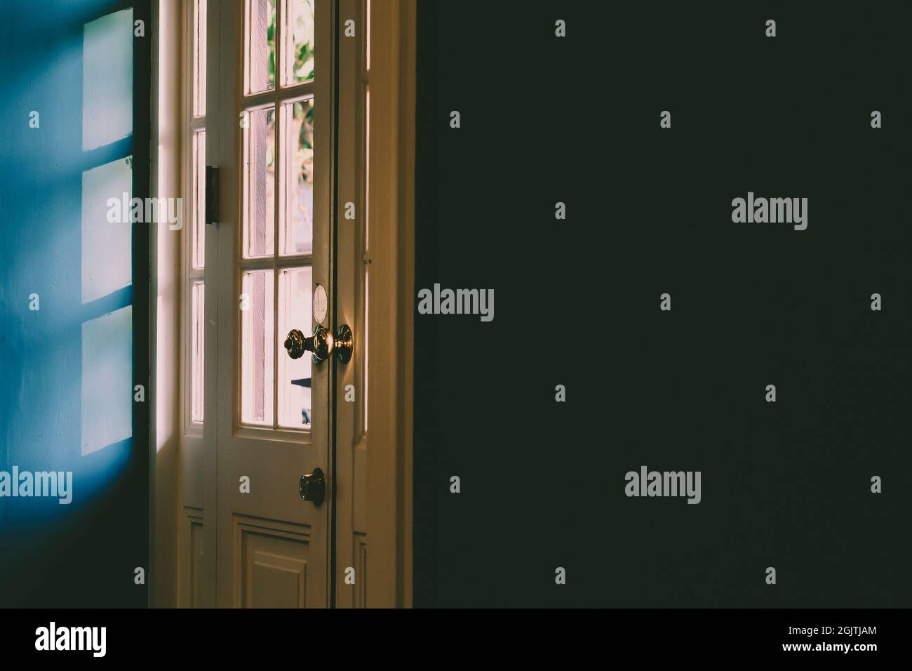 Light and shadow abstract.Sun shaded white wooden door frame and panel ...