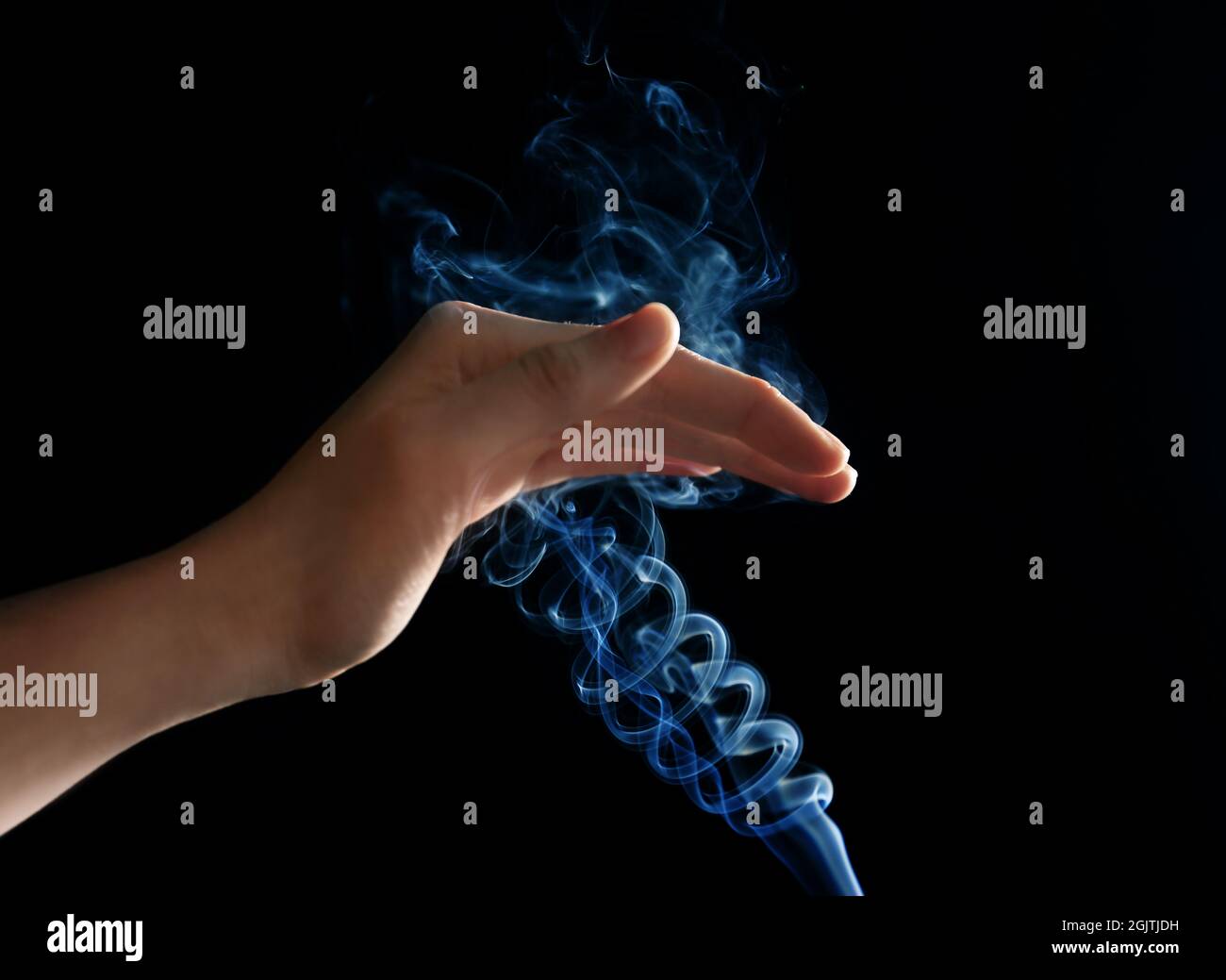 Female hand with white smoke on black background Stock Photo - Alamy