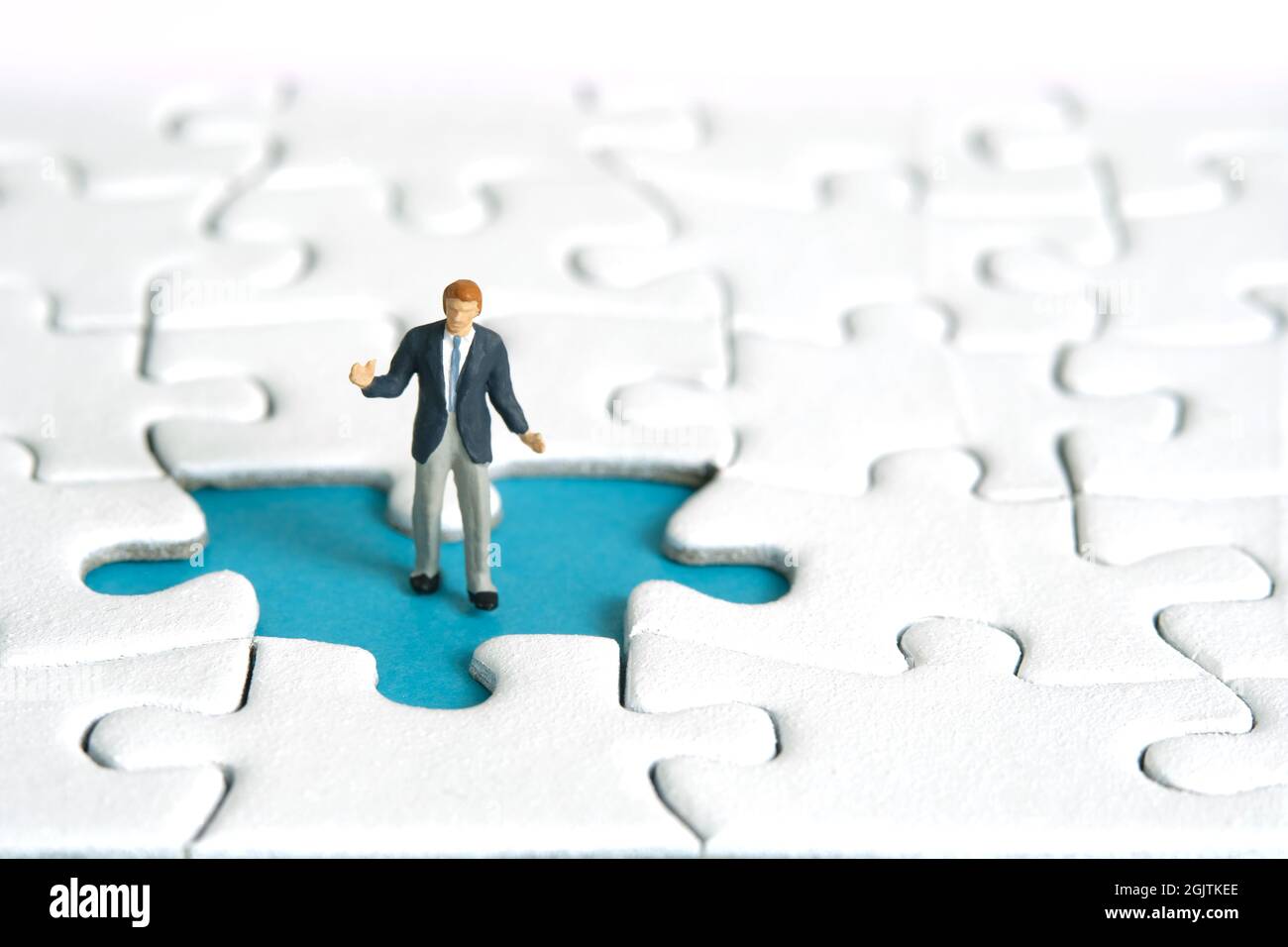 Miniature people toy figure photography. A shrugging businessman ...