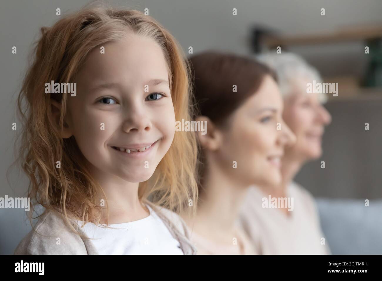 Happy three generations family posing together indoors Stock Photo - Alamy
