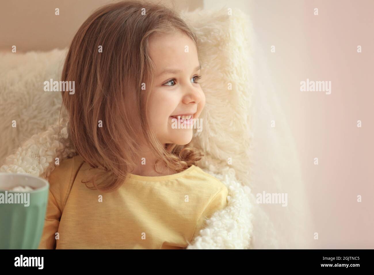 Cute little girl near window at home Stock Photo - Alamy