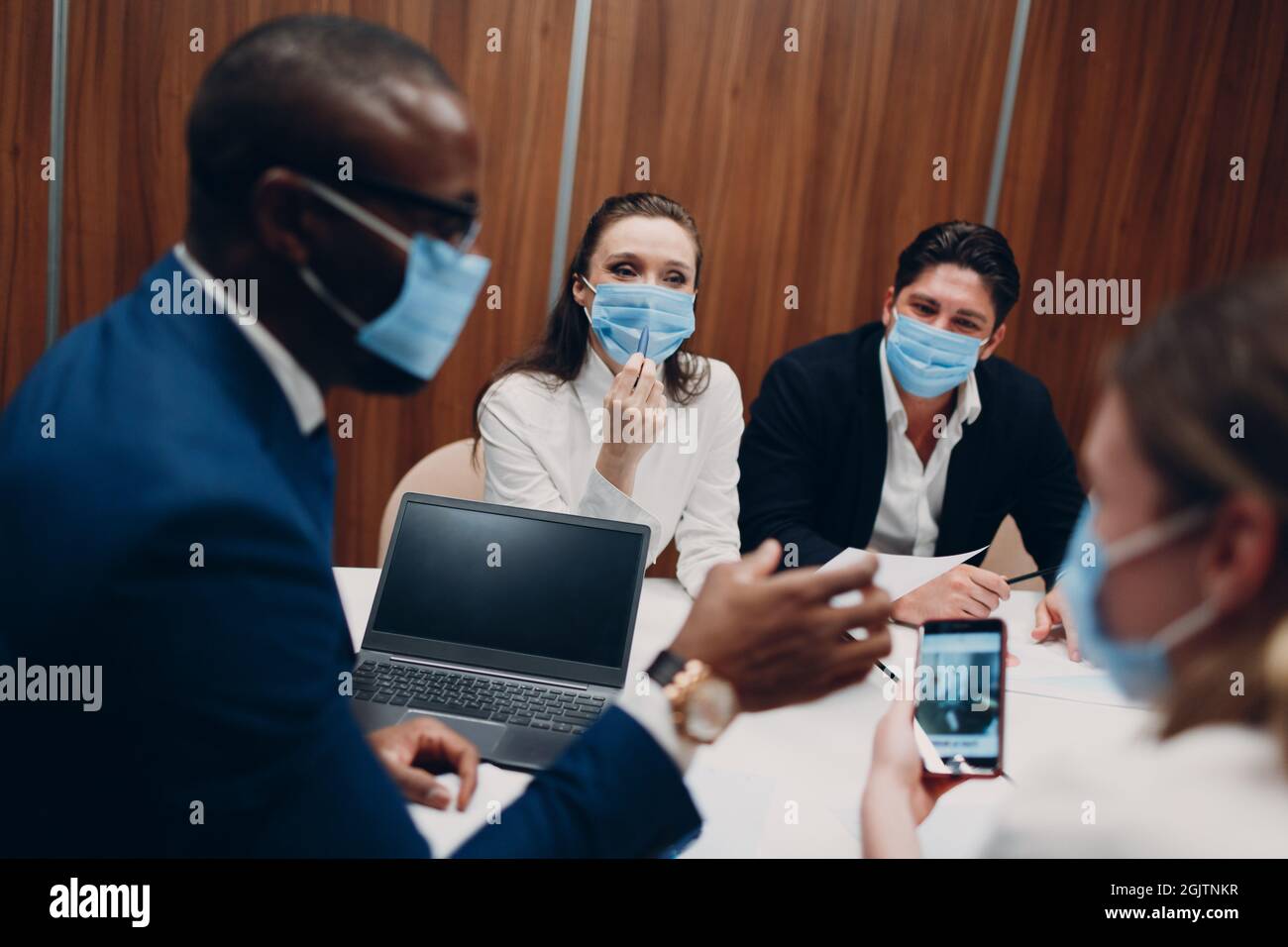 Colleagues diverse team wearing face mask office meeting. Business ...