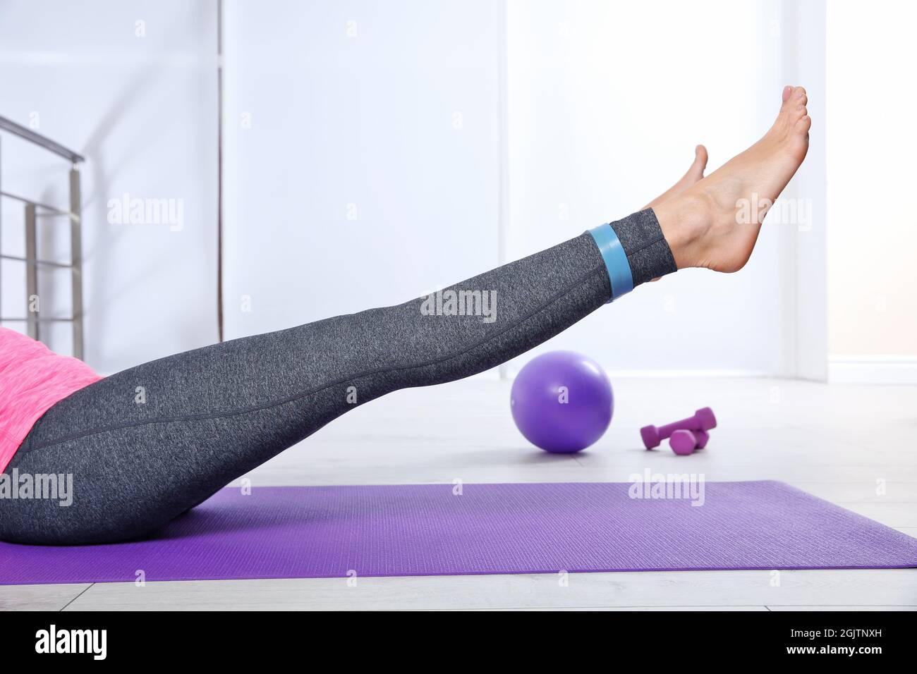Female legs training with elastic in gym Stock Photo - Alamy