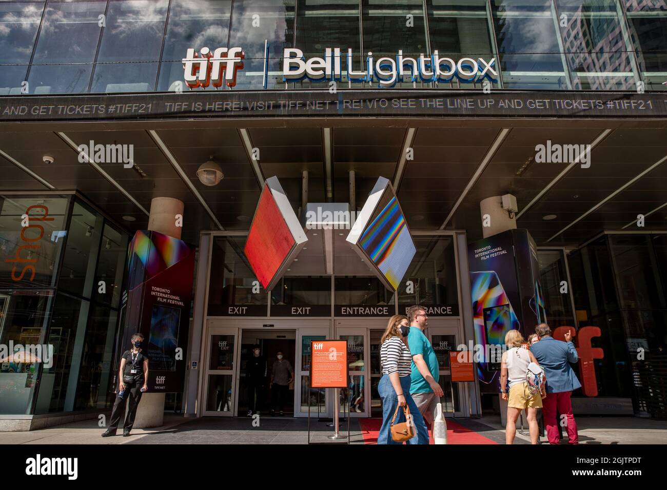 People walk past the TIFF Bell Light Box building, which is the ...