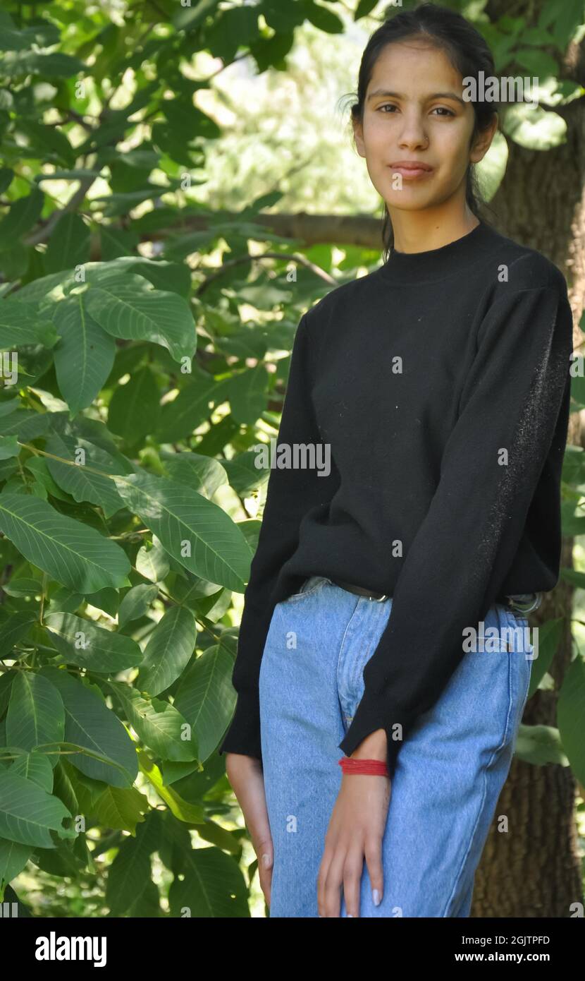 Portrait Of A Lovely Young Girl Wearing Casual Clothes Standing Against