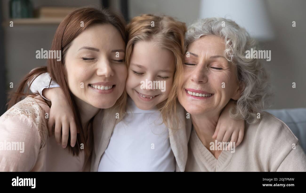 Smiling three generations family showing loving relations Stock Photo ...