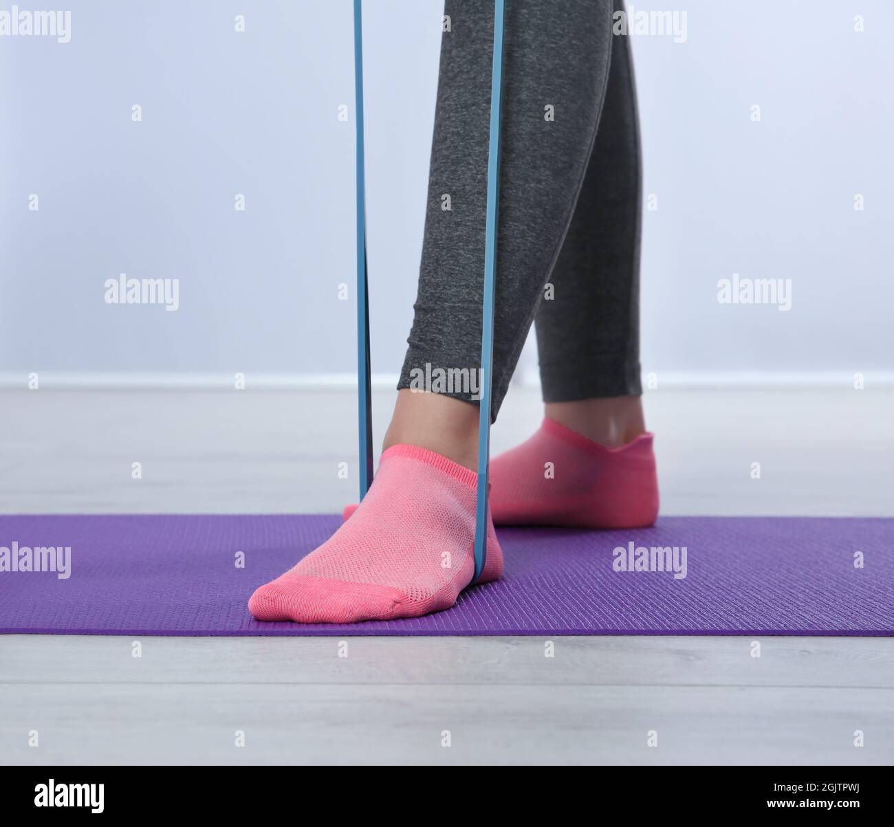 Female legs training with elastic in gym Stock Photo - Alamy