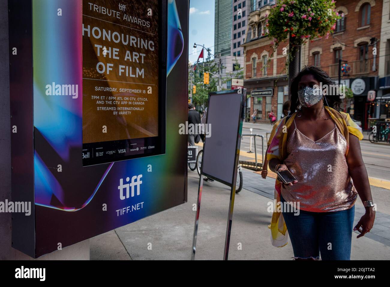 Toronto, Canada. 11th Sep, 2021. A woman walks past the TIFF Bell Light ...