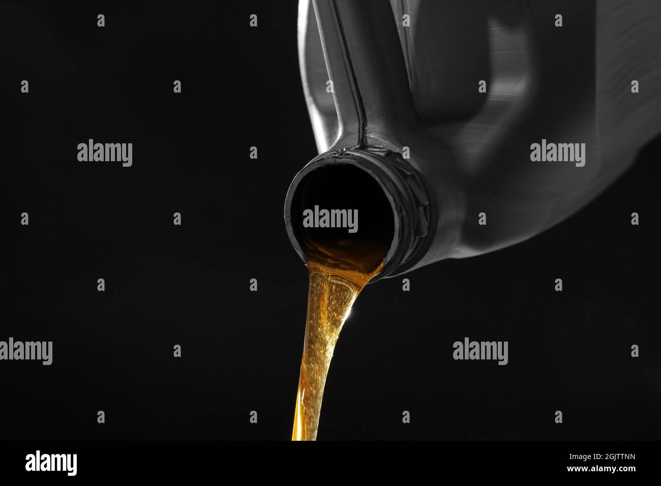 Engine oil pouring from canister on dark background, closeup Stock ...