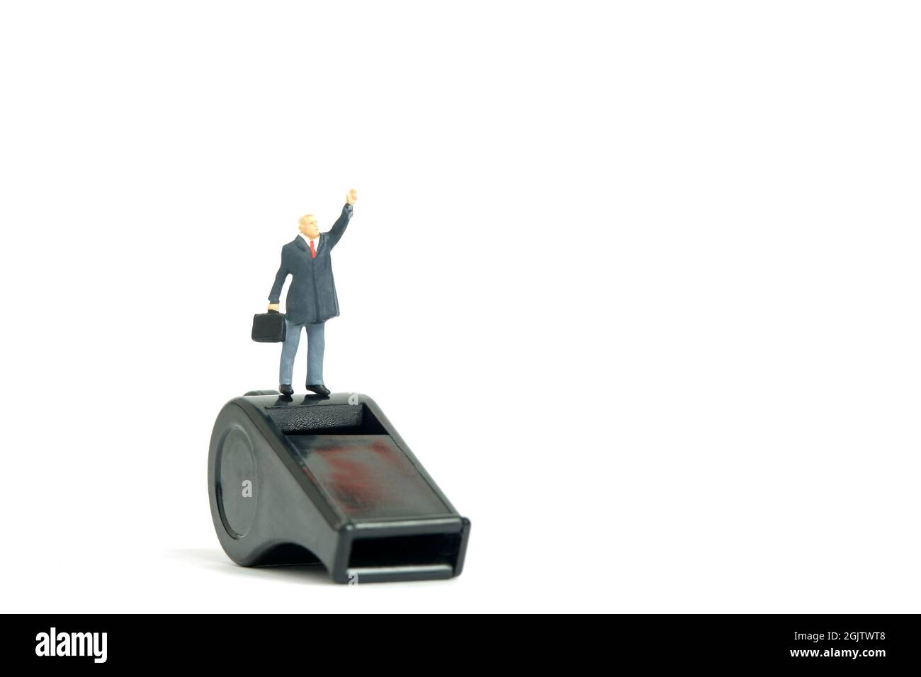 Miniature people toy figure photography. Whistle blower concepts. A ...