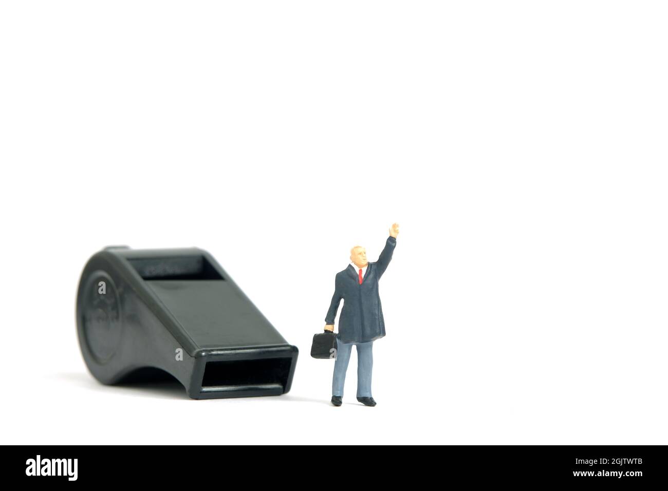 Miniature people toy figure photography. Whistle blower concepts. A ...