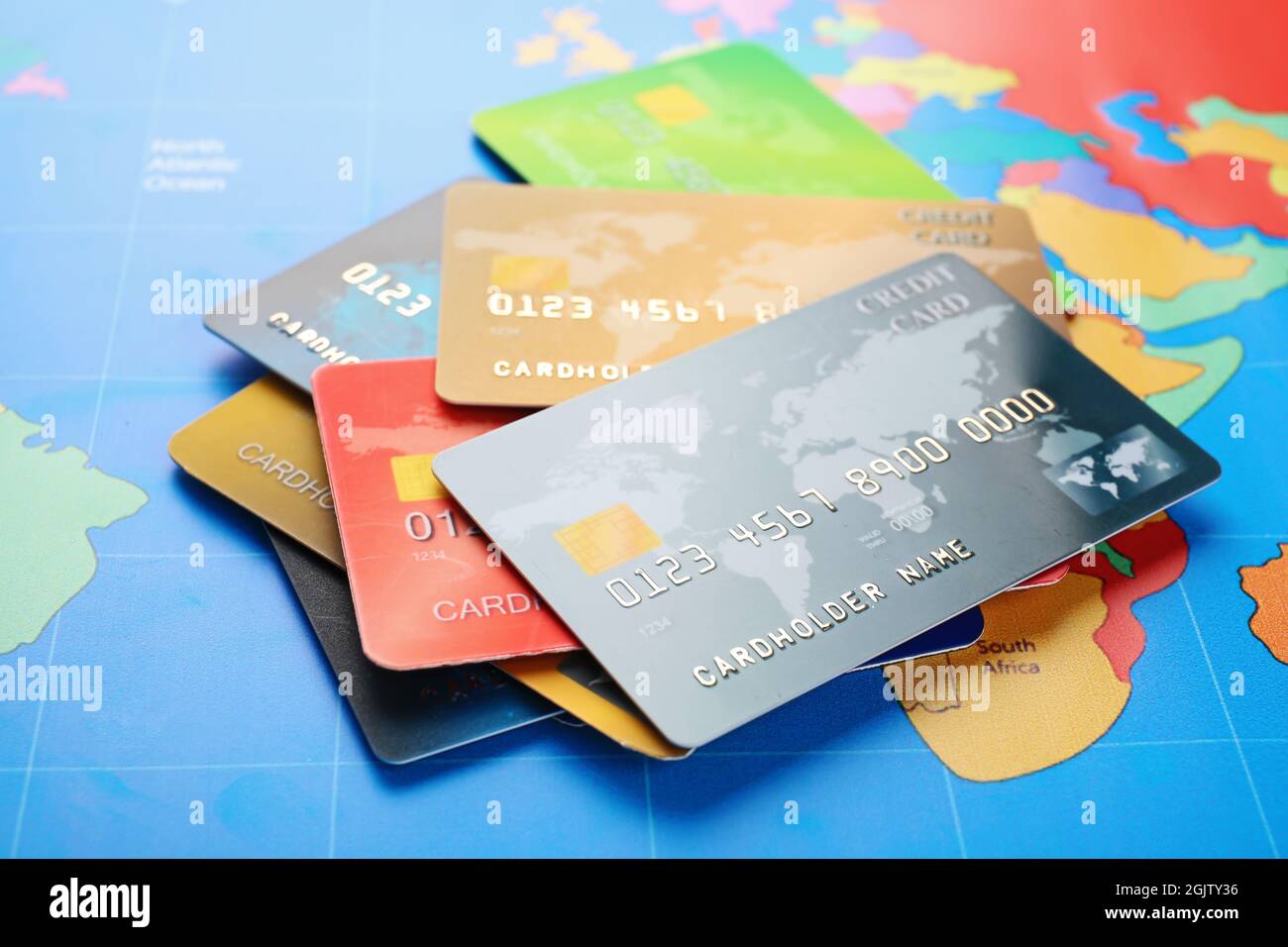Credit cards on world map background Stock Photo - Alamy