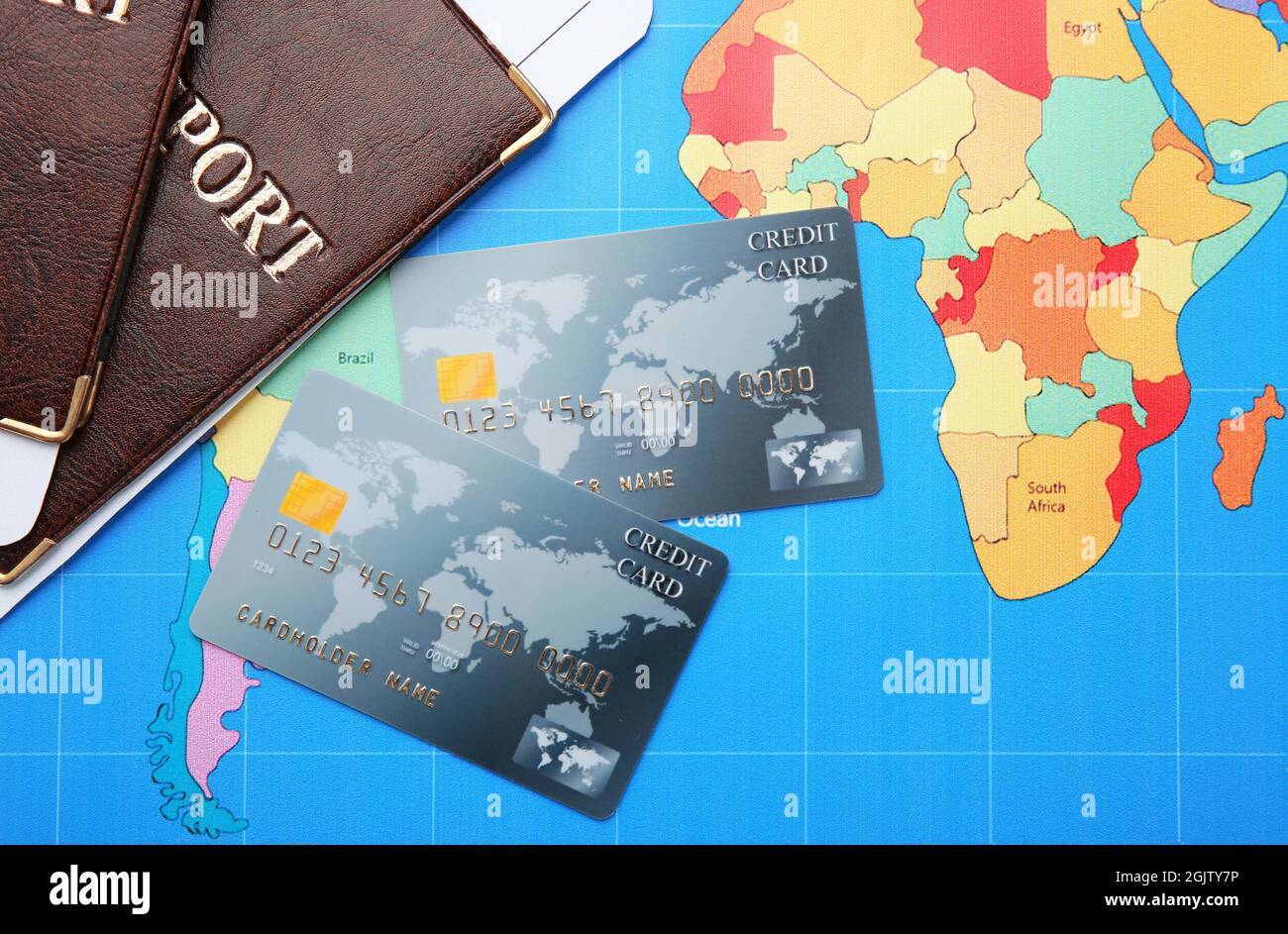 Credit cards with passports and tickets for vacations on world map ...