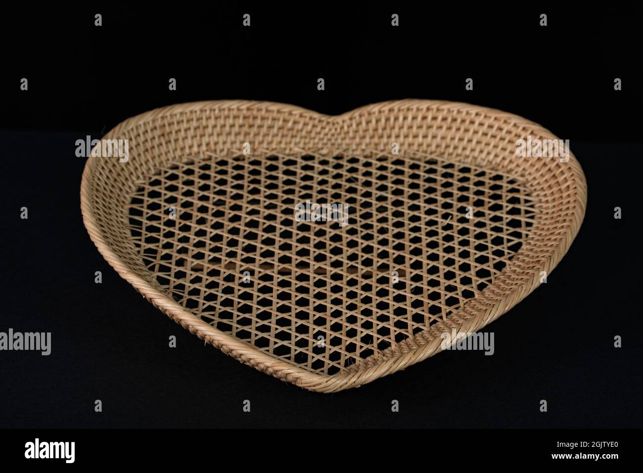 A beautiful rattan food tray on black background Stock Photo - Alamy