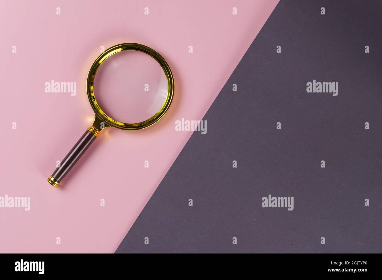 A magnifying glass on a gray-pink background. Minimalist composi Stock ...