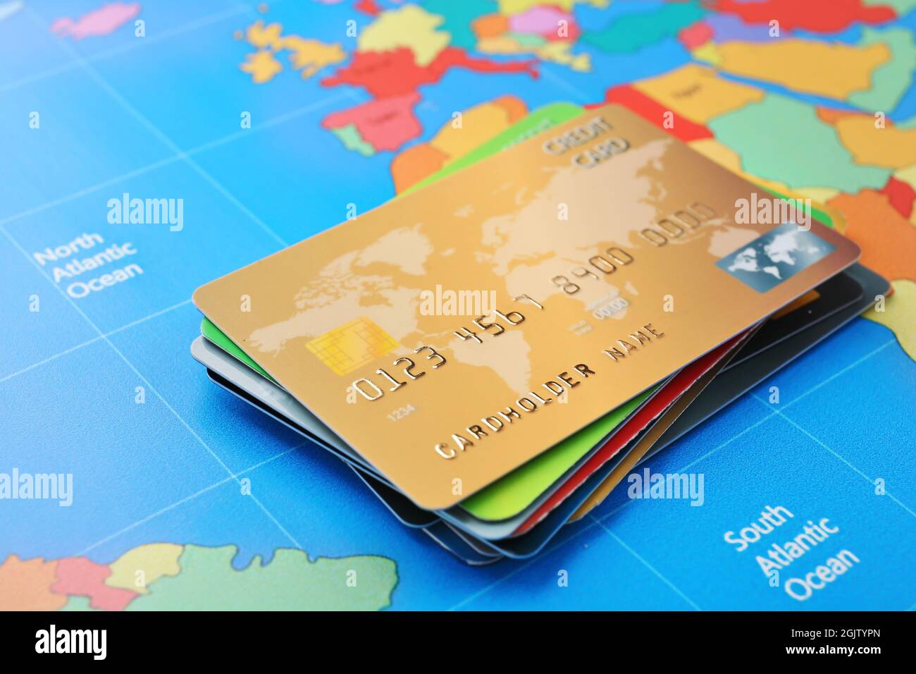 Credit cards on world map background Stock Photo - Alamy