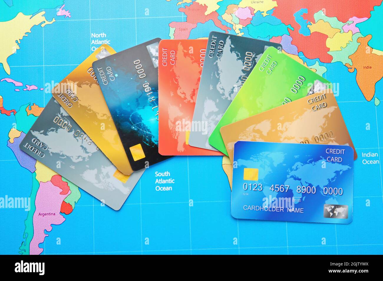 Credit cards on world map background Stock Photo - Alamy