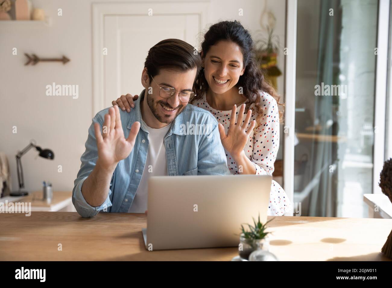 Couple make video call using laptop talking with relatives remotely ...