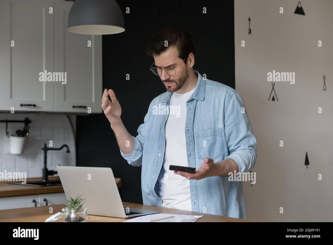 Man calculating personal finances feels stressed about financial ...