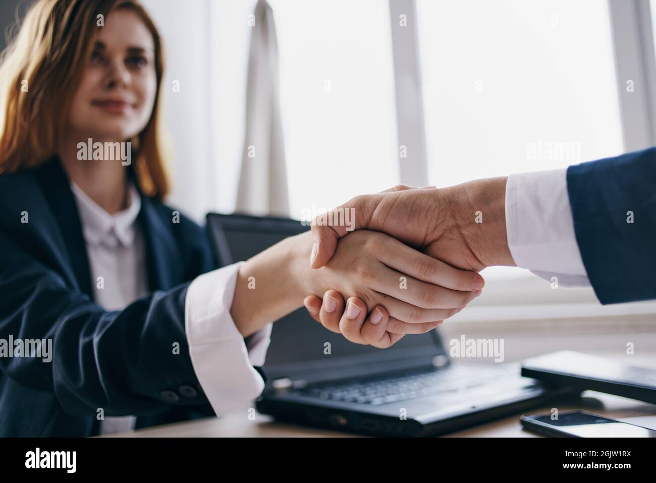 work colleagues shaking hands close-up successful deal work Stock Photo ...