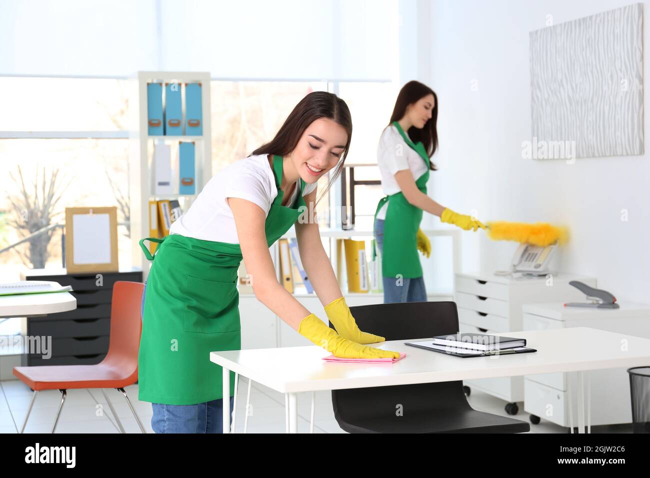 Cleaning service team working in office Stock Photo - Alamy