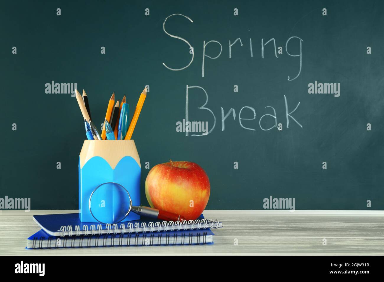 School stationery and "Spring break" text on chalkboard Stock Photo - Alamy