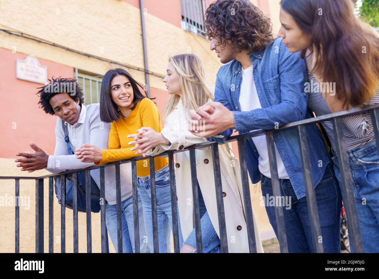 Multiracial group of young people talking together in the street Stock ...