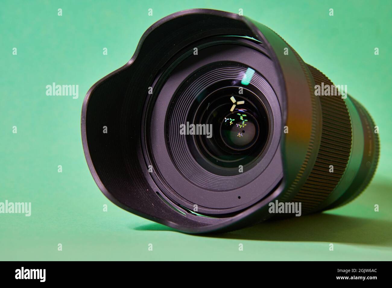 camera lens with glare on the front lens on a green background Stock ...