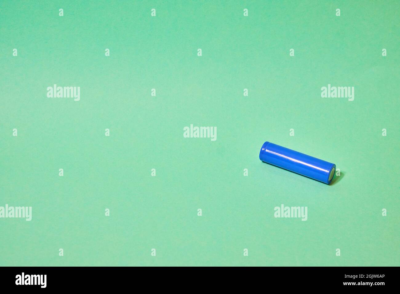blue 18650 battery on a green background Stock Photo - Alamy
