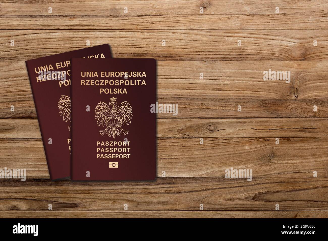 Polish passports on a wooden background, Polish nationality Stock Photo ...