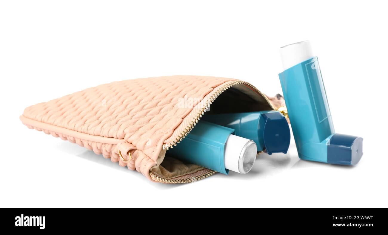 Cosmetic bag with asthma inhalers on white background Stock Photo - Alamy