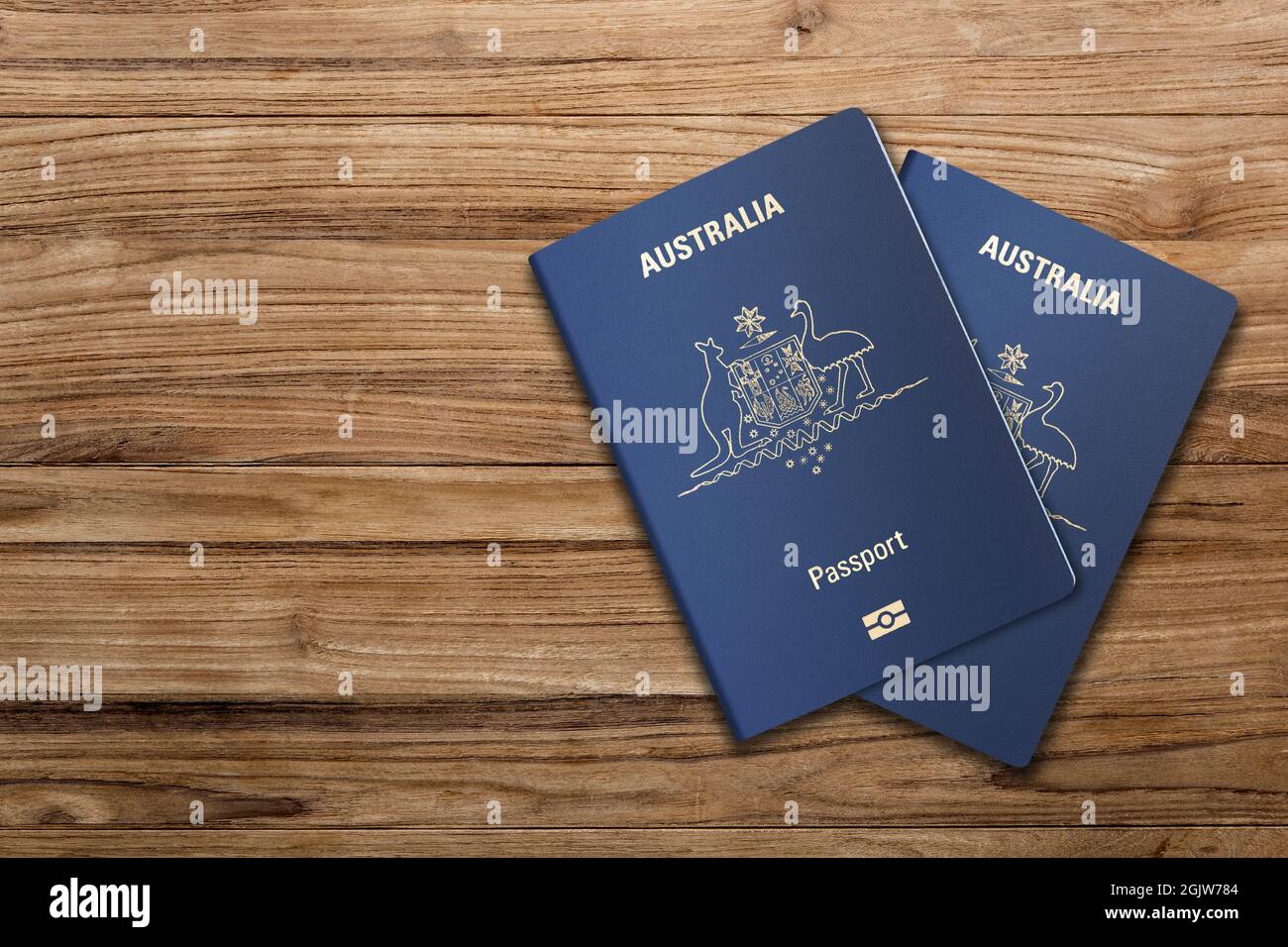 Top view, two Australian passports on a wooden board Stock Photo - Alamy