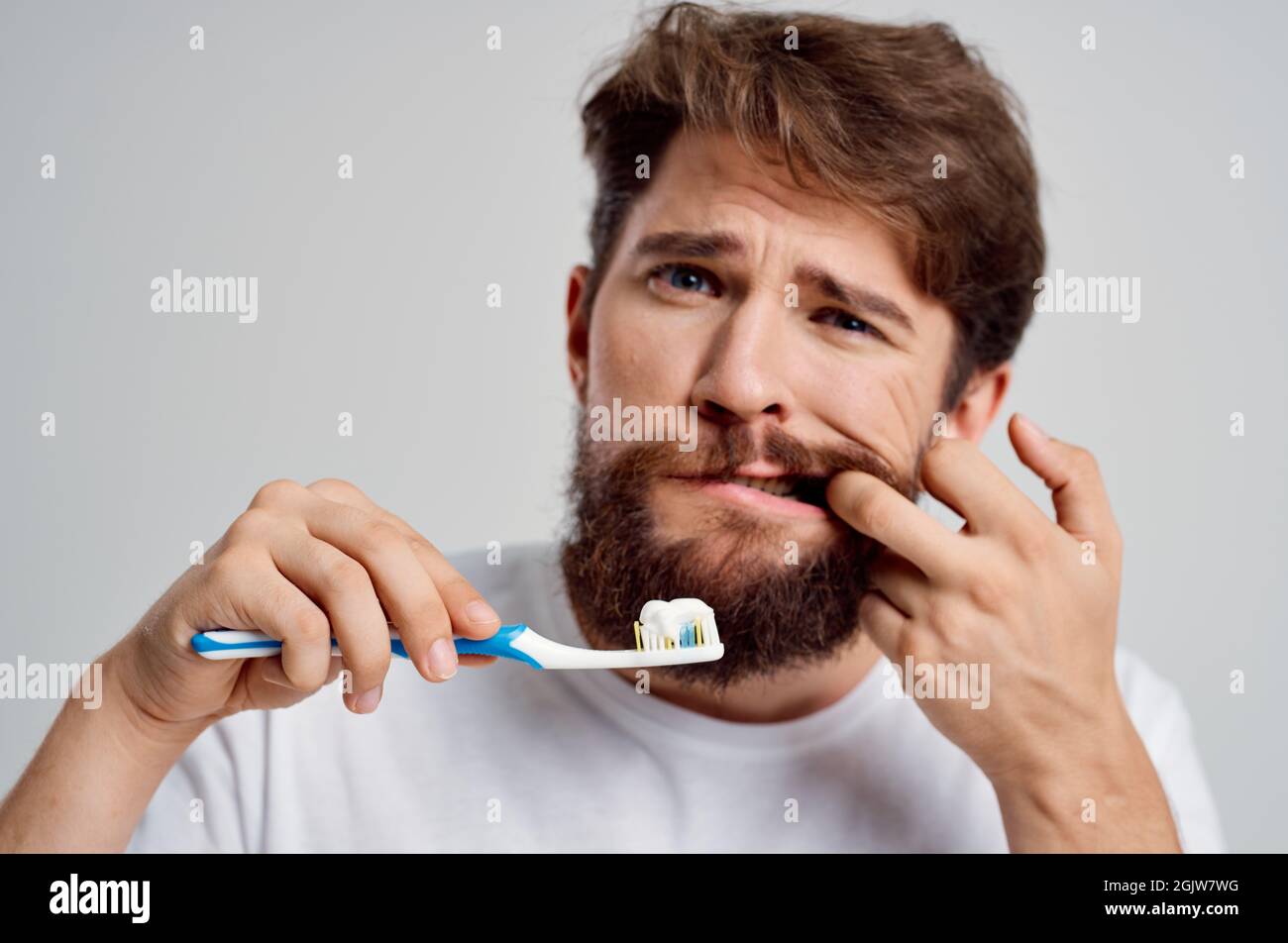 man toothbrush in hand hygiene clean teeth light background Stock Photo ...