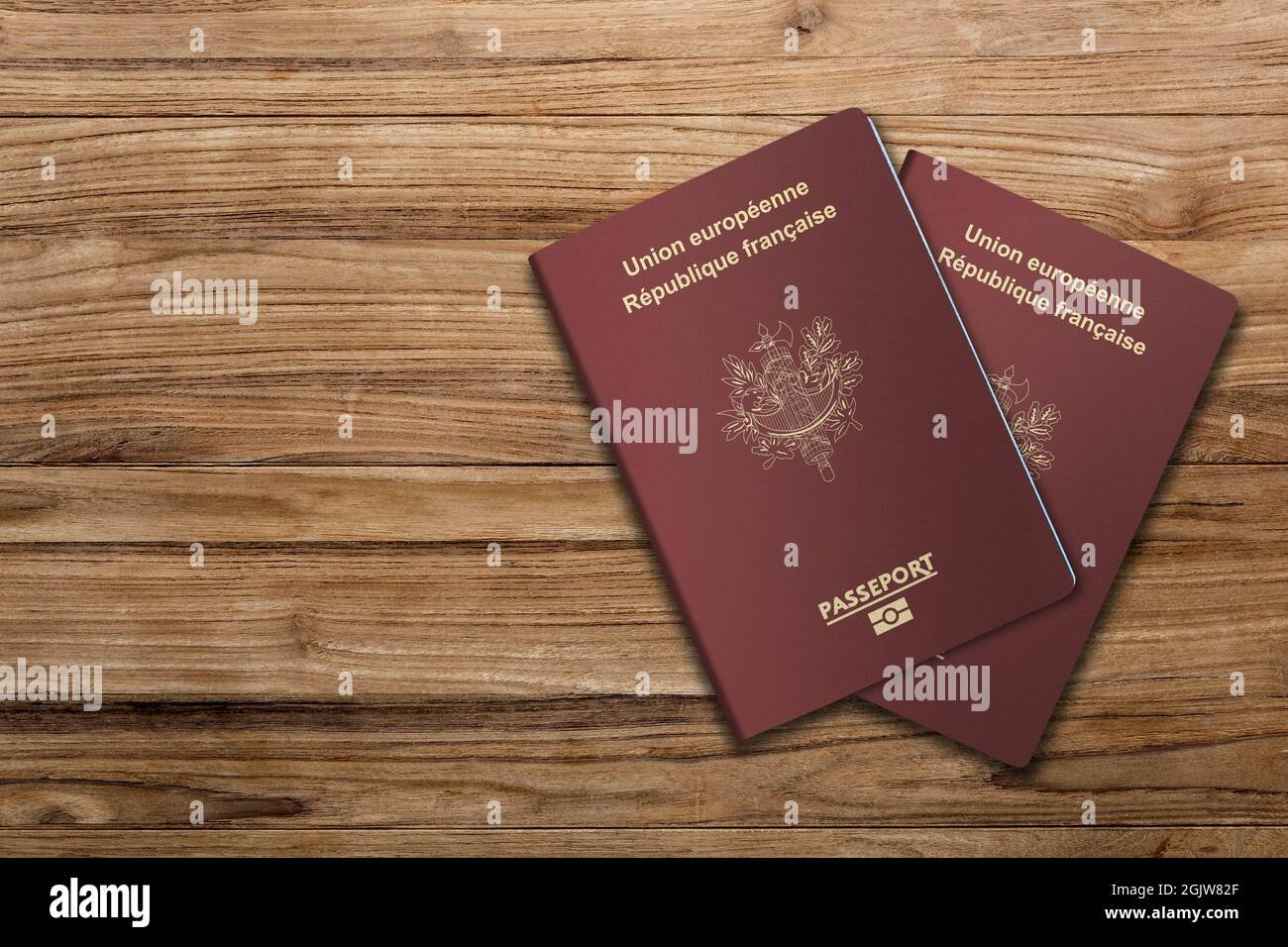 Two French passports on dark wooden board Stock Photo - Alamy