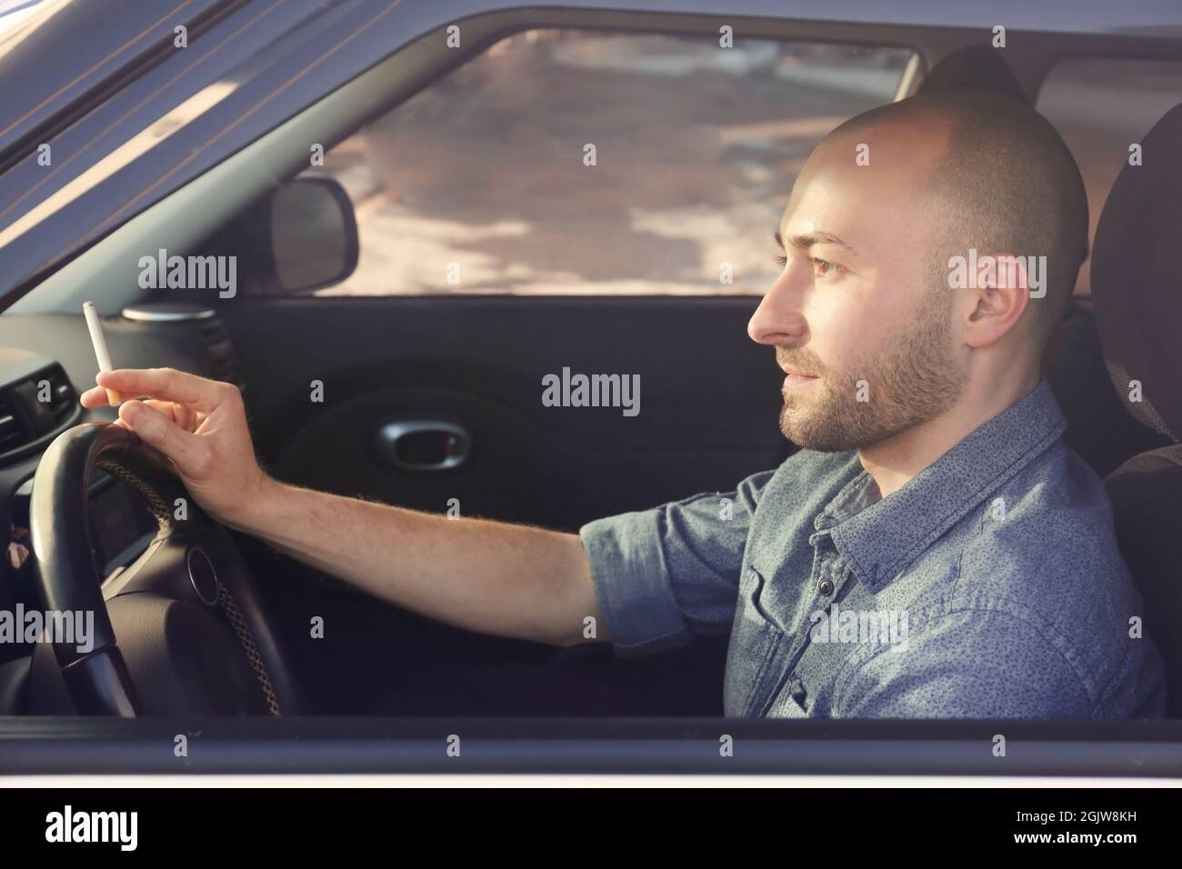 Young male smoking in car hi-res stock photography and images - Alamy