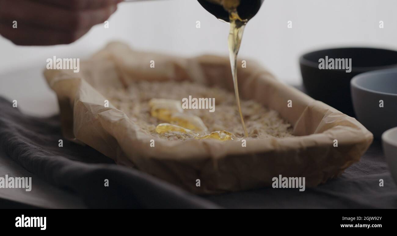 man making granola at home, pour honey, wide photo Stock Photo - Alamy
