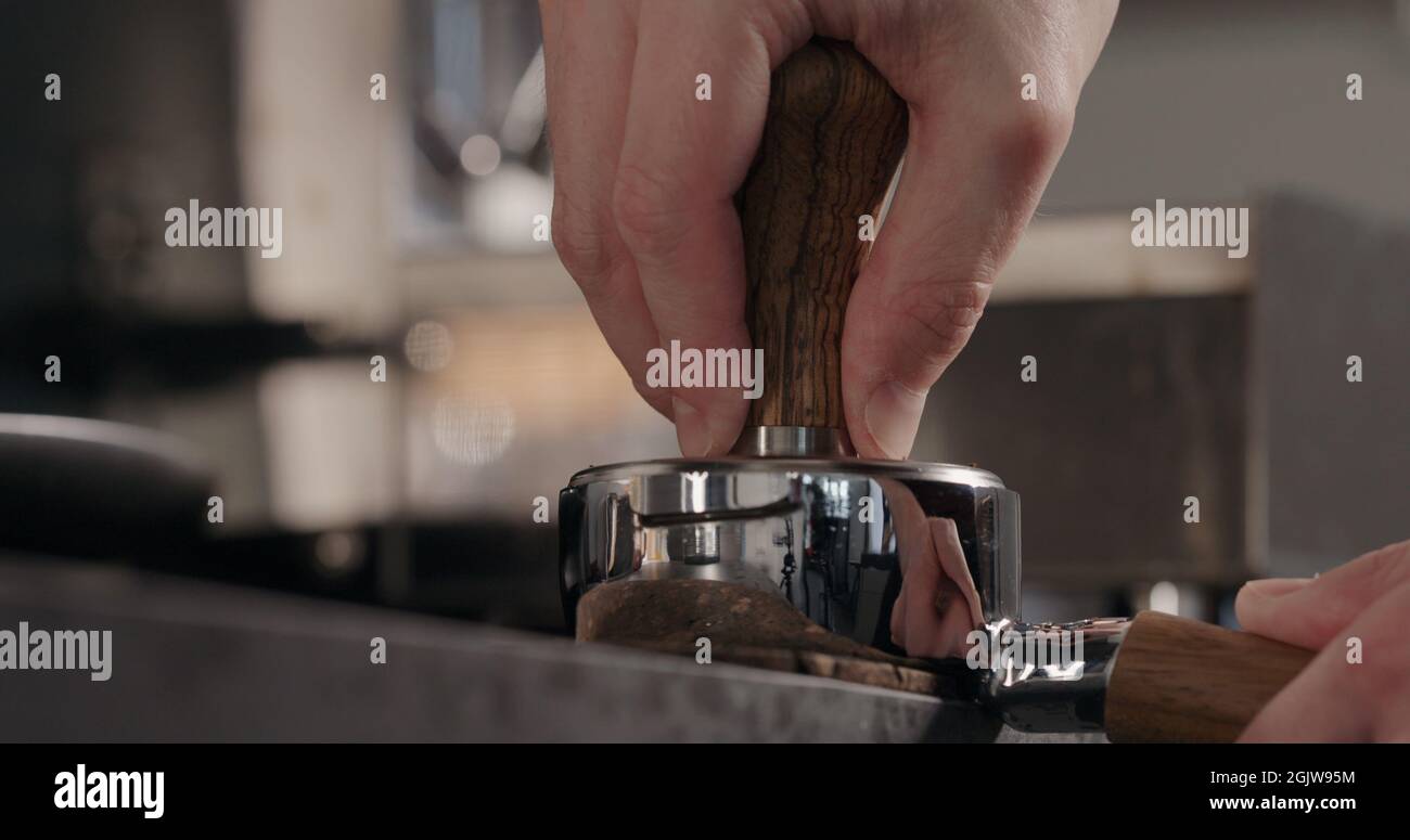 Hand tamping fresh ground coffee hi-res stock photography and images ...