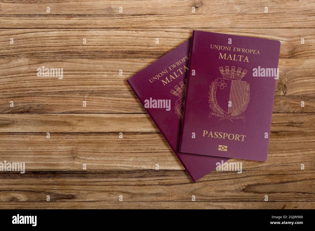 Malta passport, carried by a Maltese citizen, two passports on a wooden ...