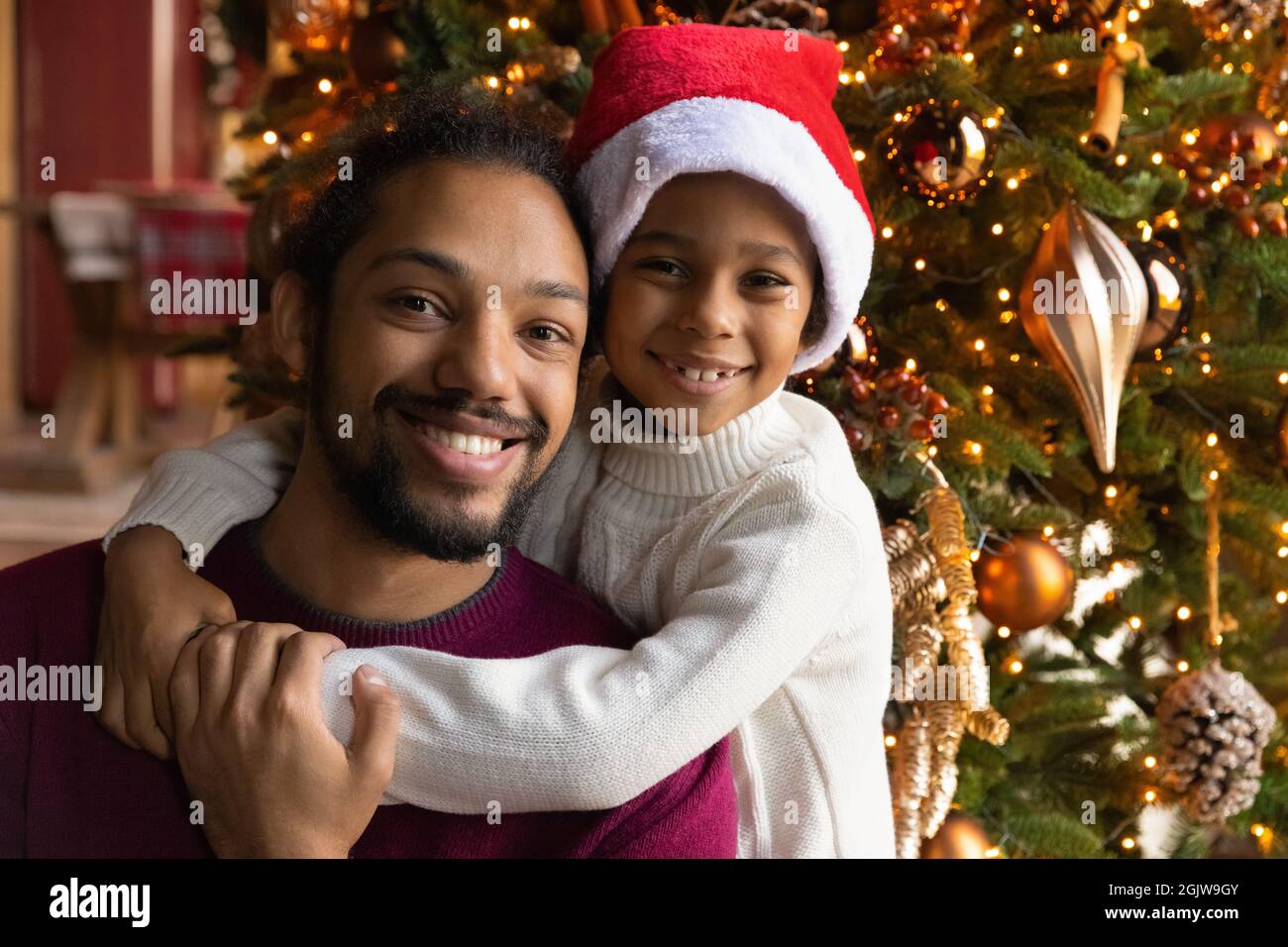 Portrait of smiling ethnic dad and son celebrate Christmas Stock Photo ...