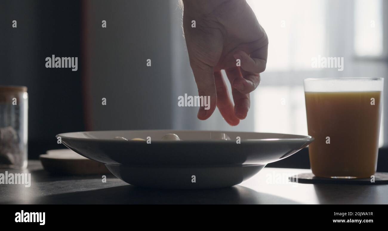 man add mozzarella to penne pesto , wide photo Stock Photo - Alamy