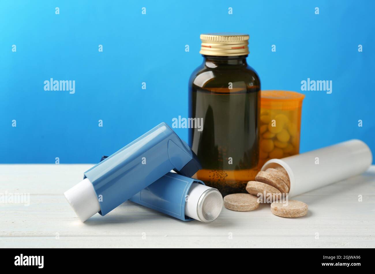 Asthma inhalers with medicines on blue background Stock Photo - Alamy