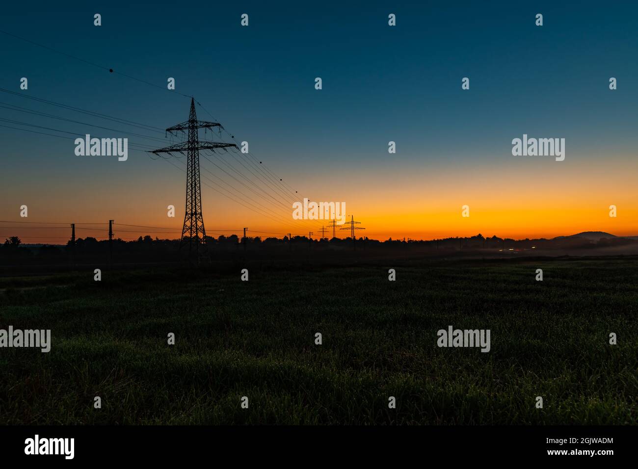 Electricity pylons in the sunset Stock Photo - Alamy