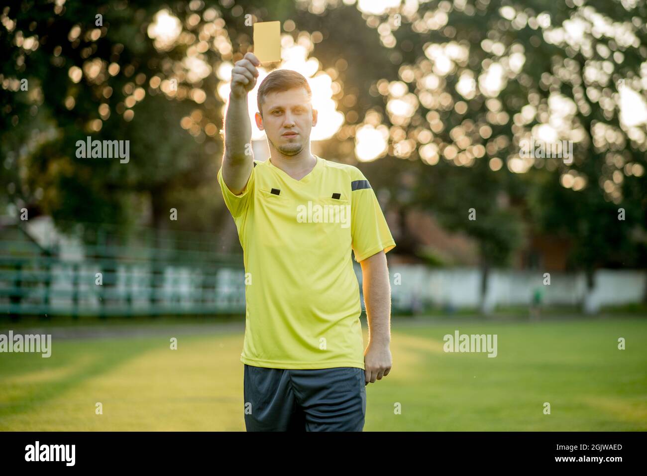 Soccer referee to point out a yellow card to a player in the soccer ...