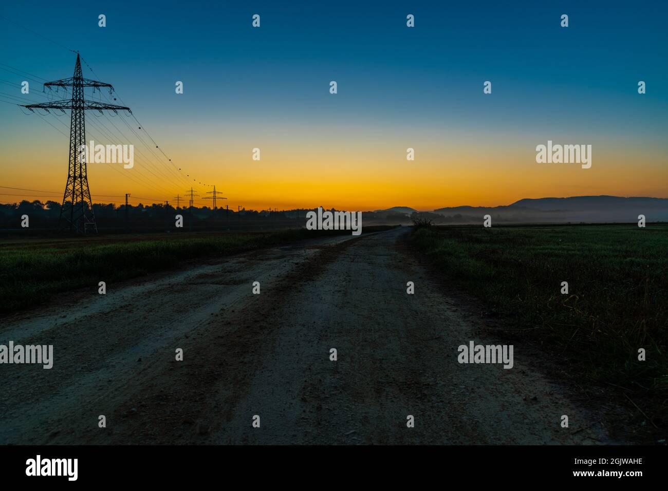 Electricity pylons in the sunset Stock Photo - Alamy