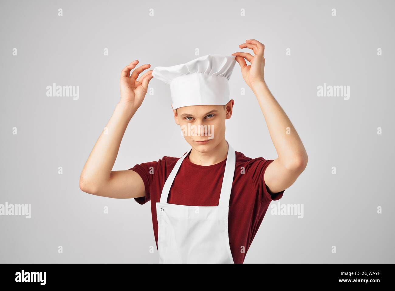 man in a white apron with a cap on his head working uniform kitchen ...