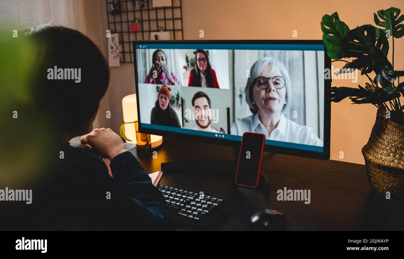 Multi generation business woman having video call with colleagues using ...