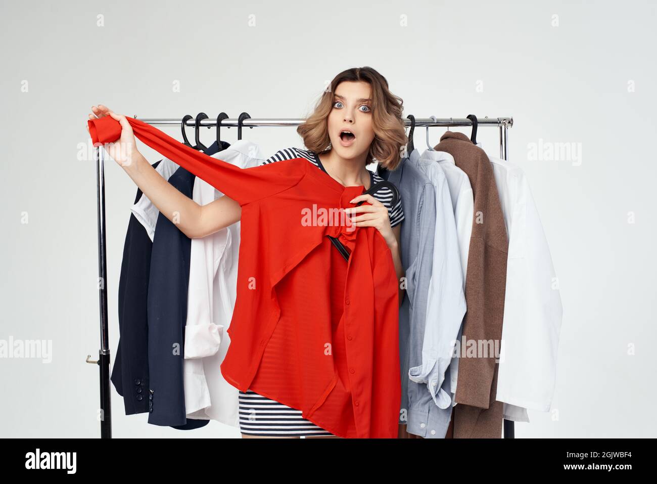 beautiful woman near clothes shopaholic isolated background Stock Photo ...