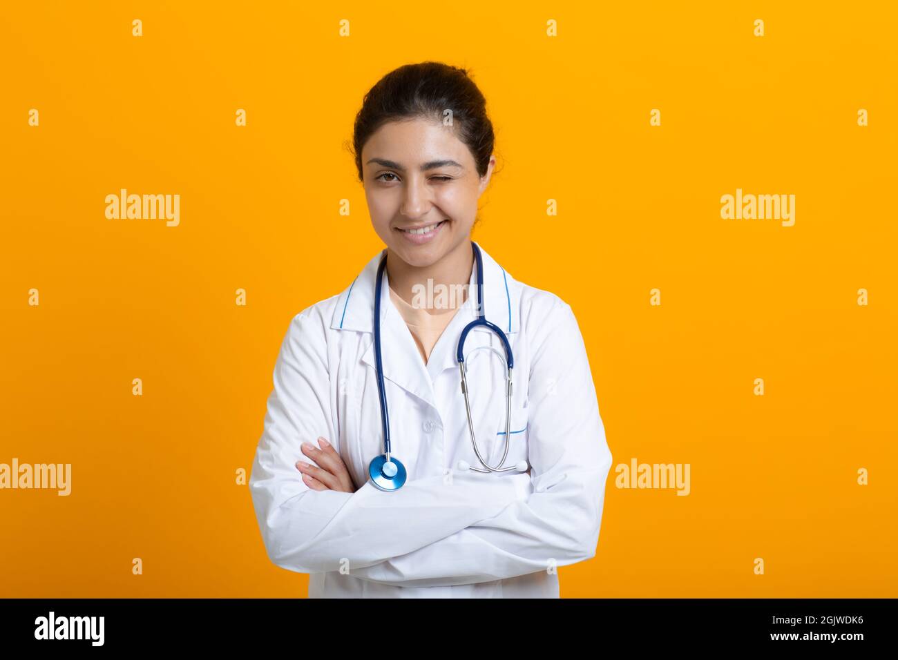 Portrait of indian wink doctor woman in white medical gown stethoscope ...